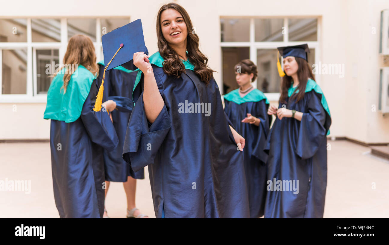 A group of young female graduates. Female graduate is smiling against ...