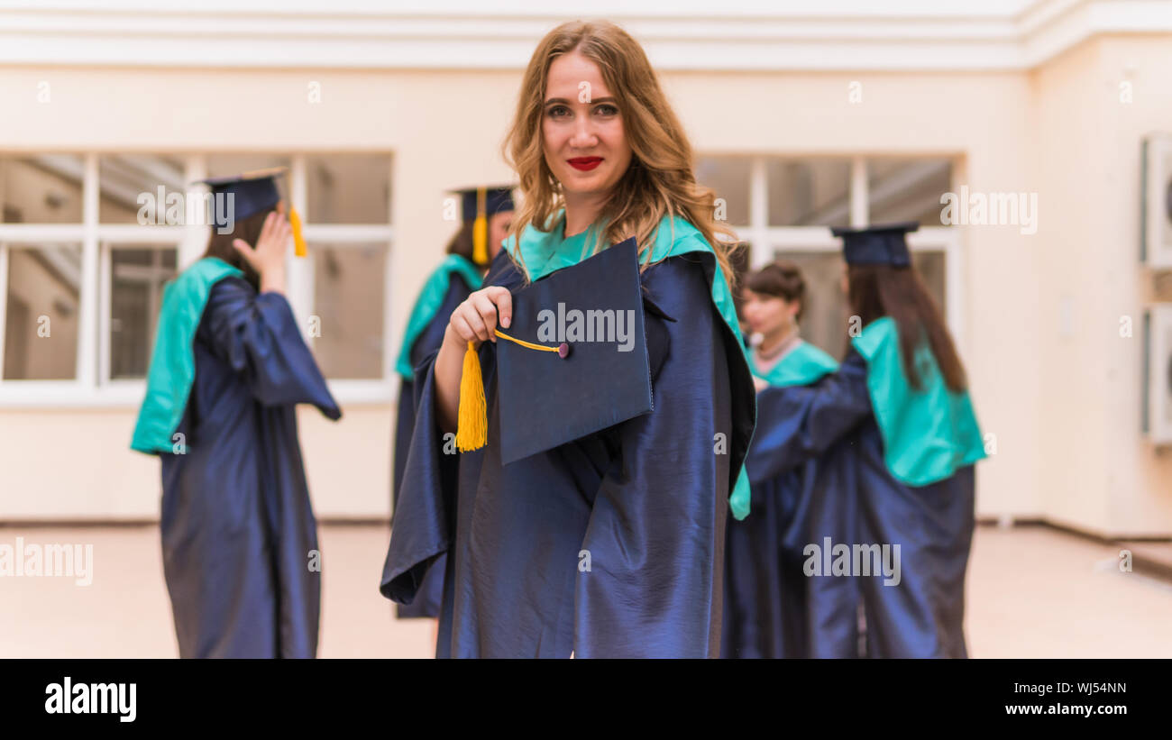 A group of young female graduates. Female graduate is smiling against ...