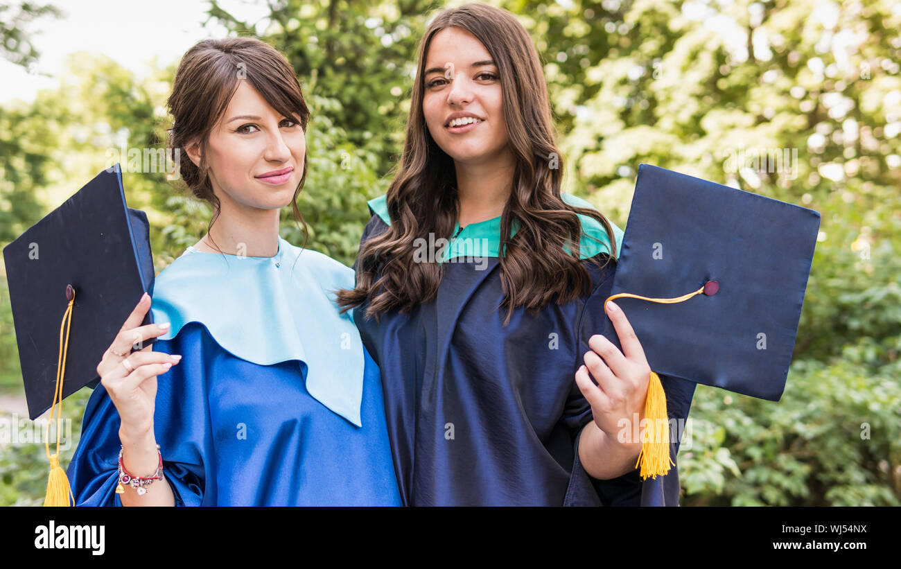 A group of young female graduates. Female graduate is smiling against ...