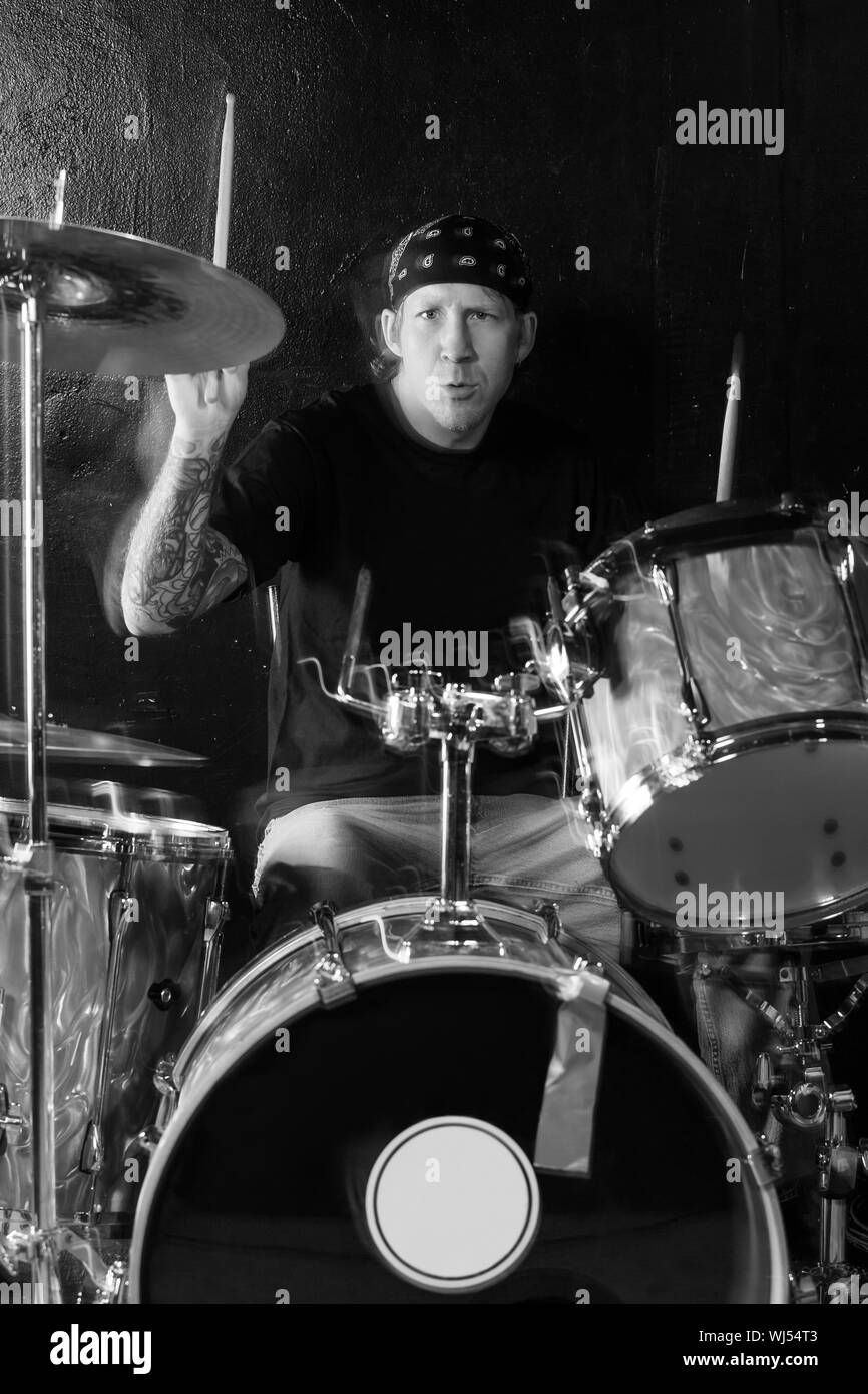 Photo of a drummer playing his kit. Visible movement on the head, arms ...