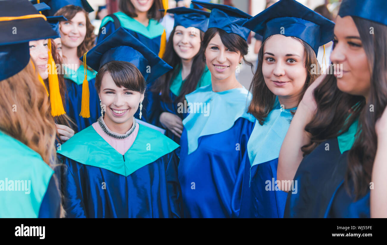 A group of young female graduates. Female graduate is smiling against ...