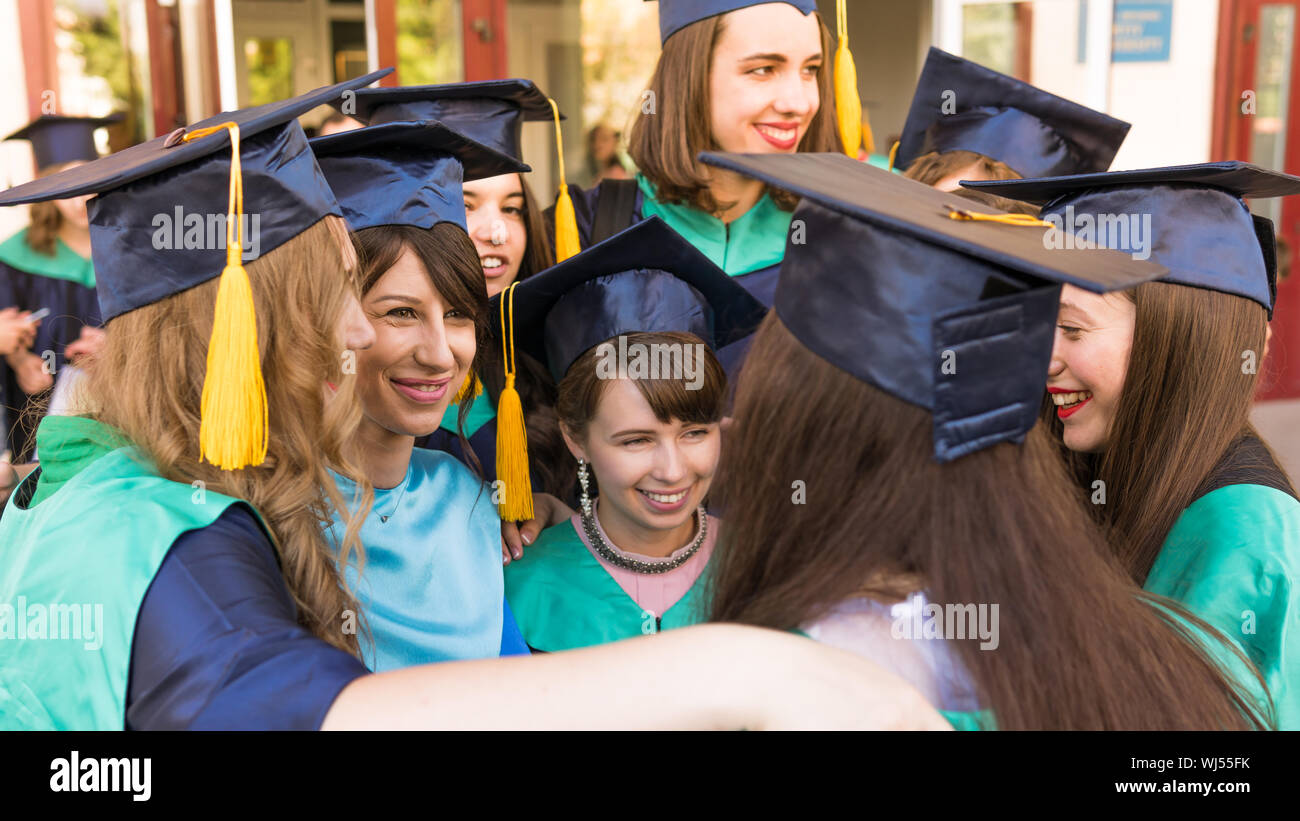 A group of young female graduates. Female graduate is smiling against ...