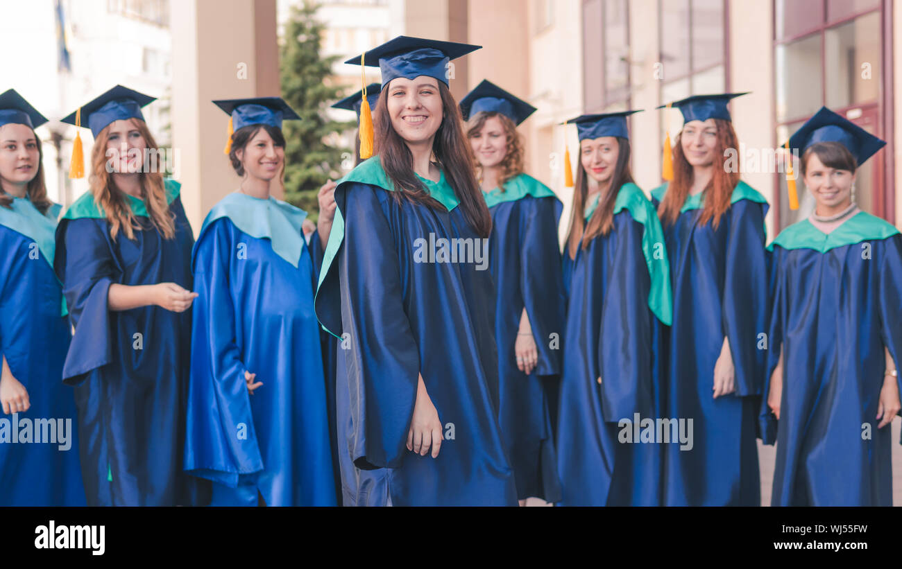 A group of young female graduates. Female graduate is smiling against ...