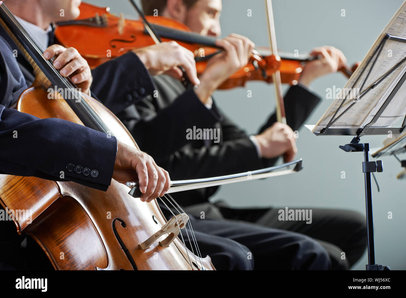 Cellist and violinist playing at the concert Stock Photo - Alamy