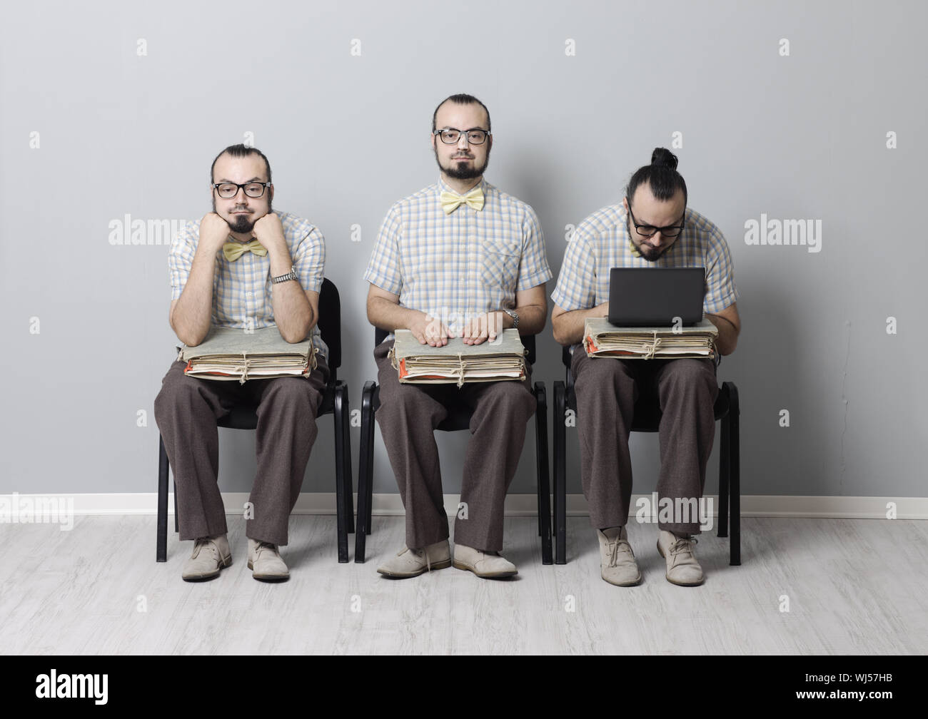 Conceptual image of three men waiting for an interview Stock Photo - Alamy