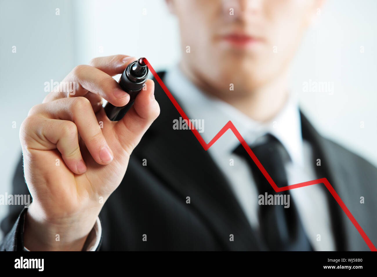 Businessman Hand drawing a graph Stock Photo - Alamy