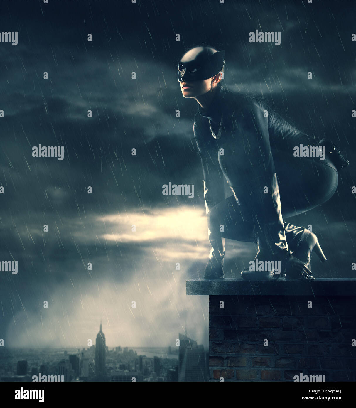 Female Superhero watching over the city Stock Photo - Alamy