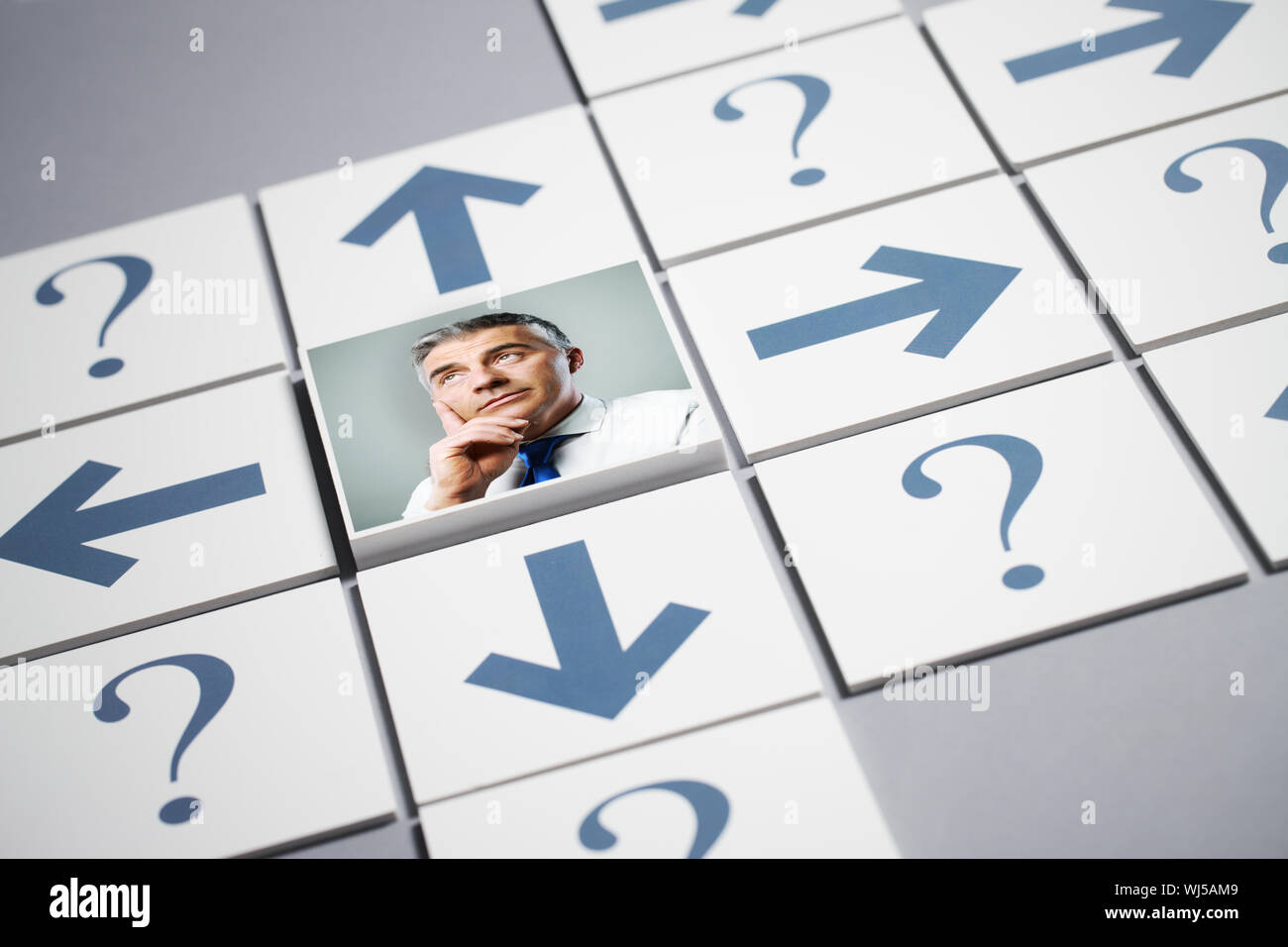 Senior businessman thinking surrounded by question marks and arrows ...