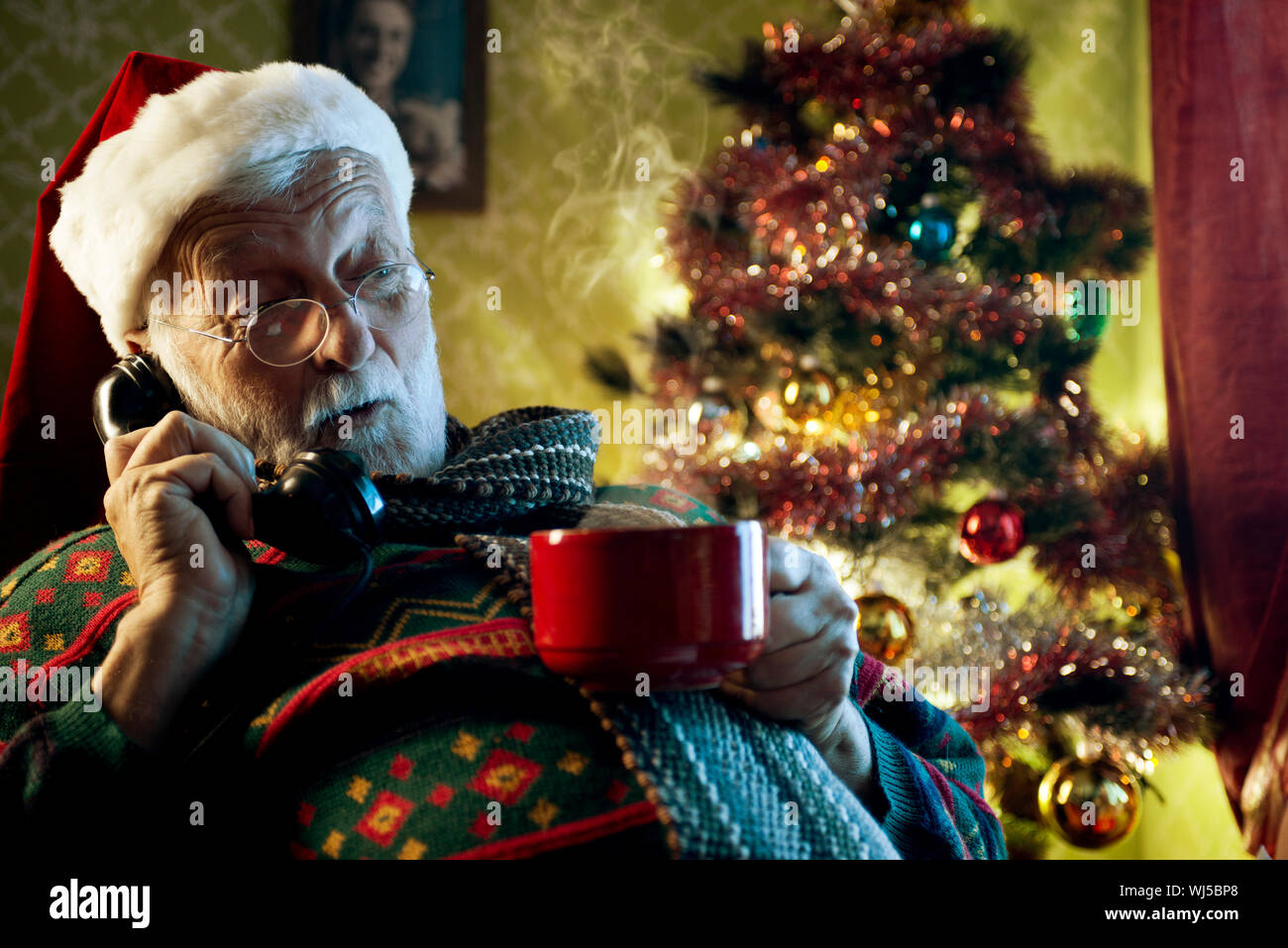 Pictures of Santa Claus relaxing at home and talking on phone Stock ...
