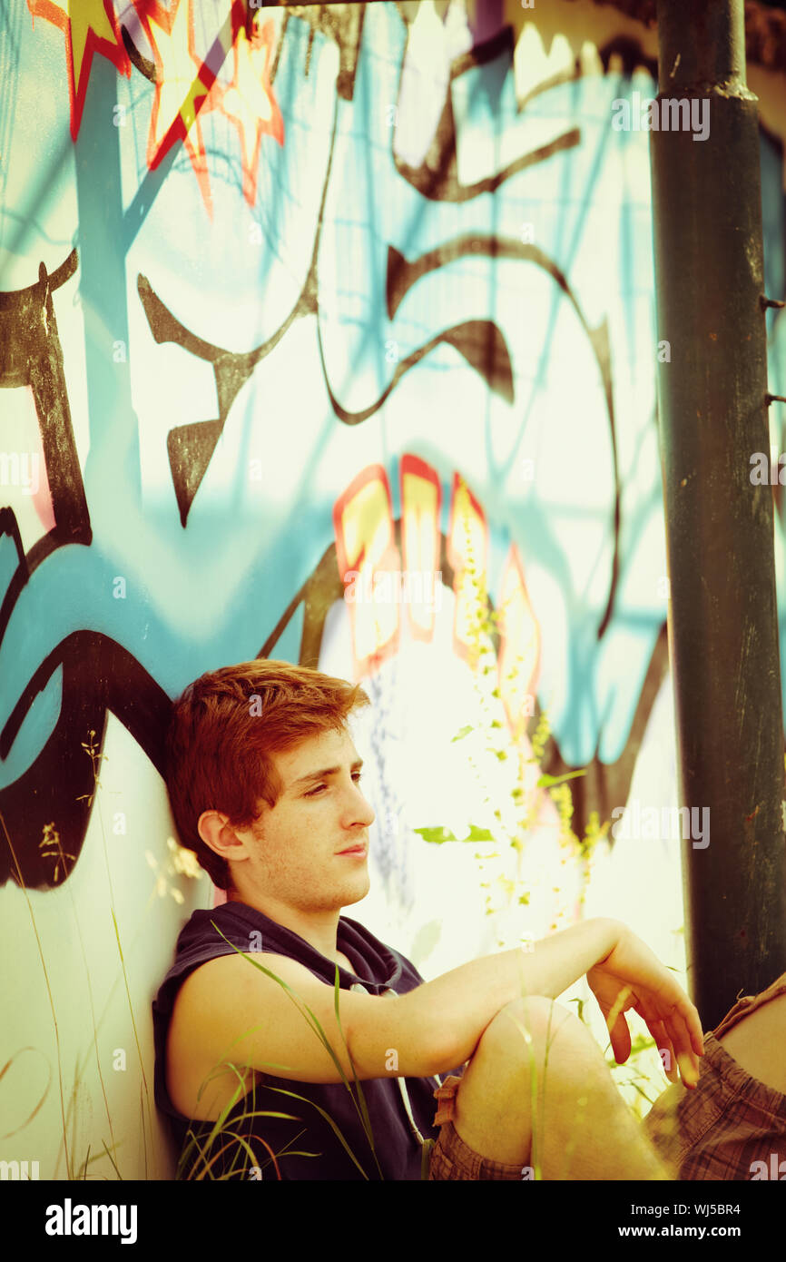 Boy against graffiti wall hi-res stock photography and images - Alamy