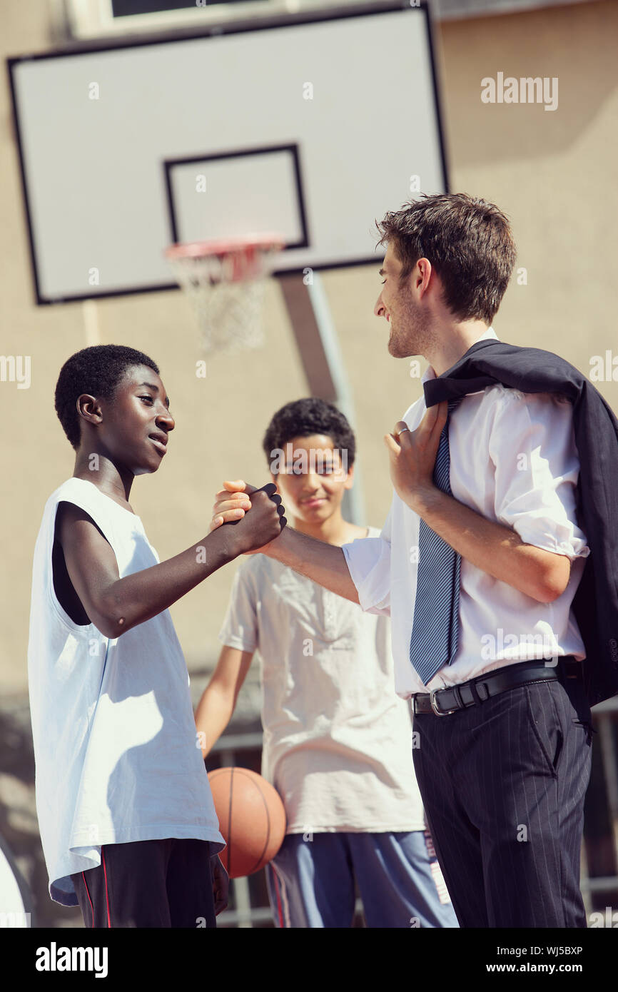 Multi-Ethnic Basketball players shaking hands after match Stock Photo ...