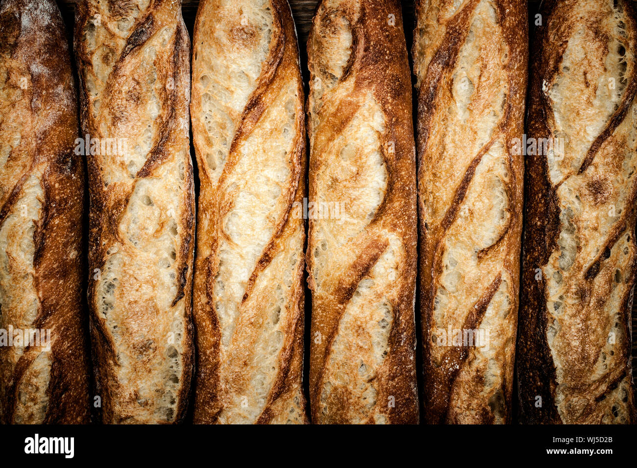 Fresh artisan baguette bread loaves in a row Stock Photo - Alamy