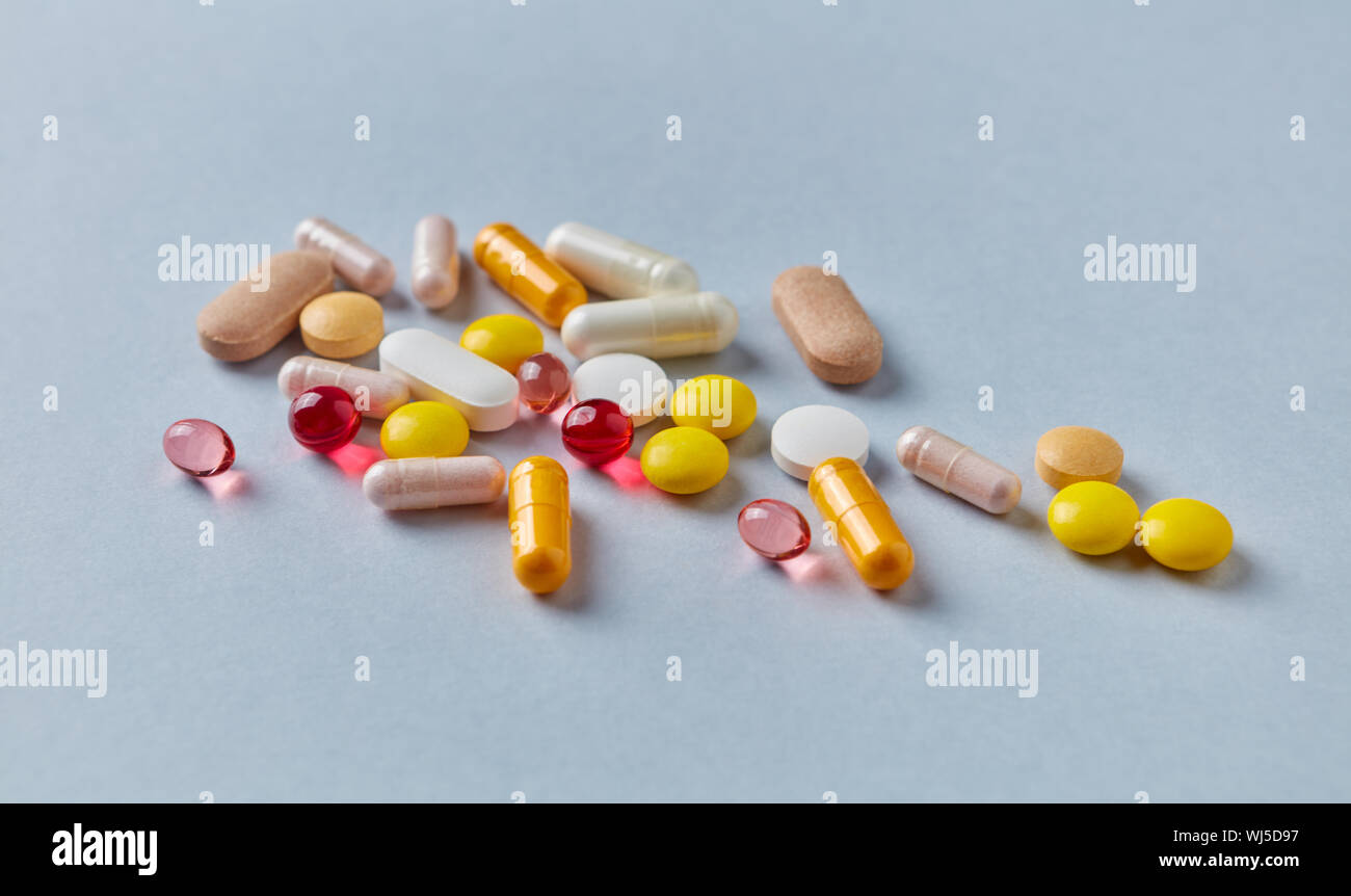 Vitamins and supplements on bright paper background. Concept for a ...