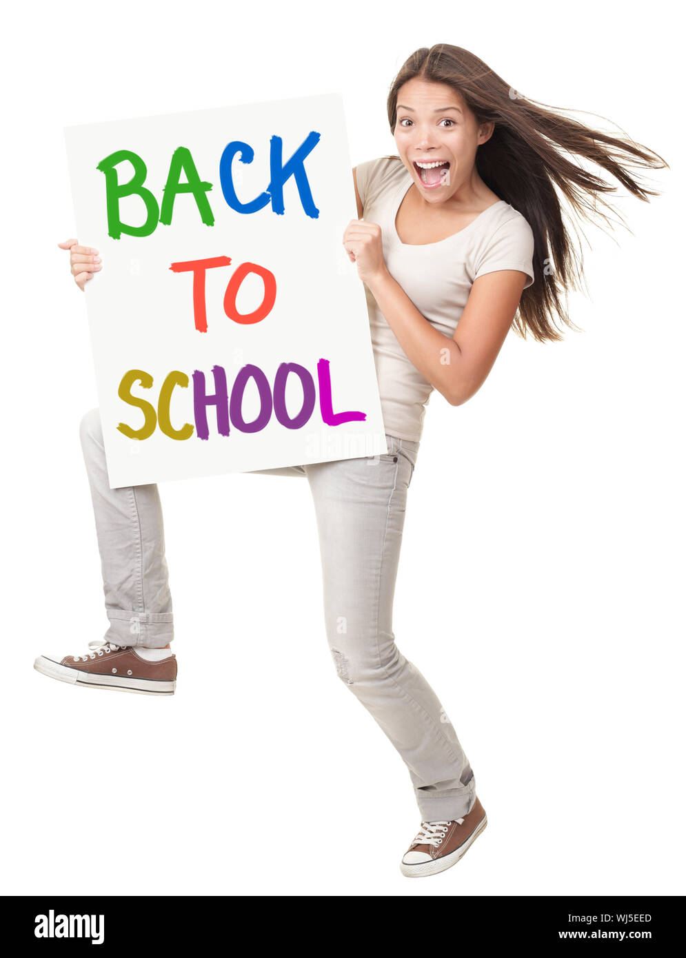 Back to school / university / college. Female student holding a sign ... Back to school / university / college. Female student holding a sign ...