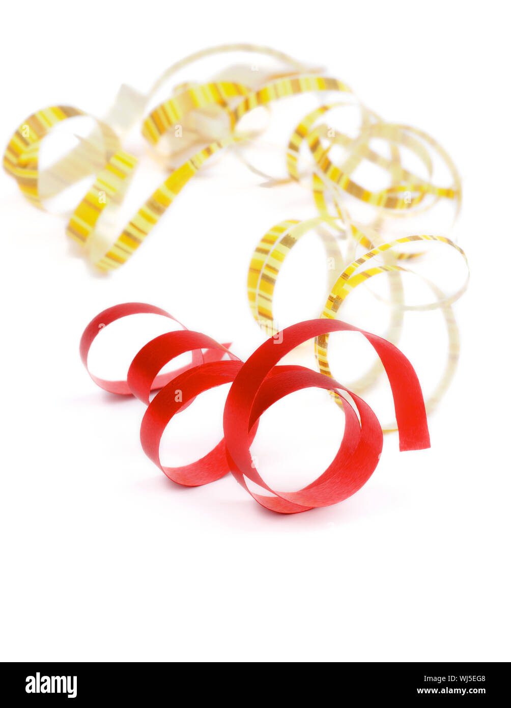 Curly Party Streamers Red and Yellow Striped Lying on white background ...