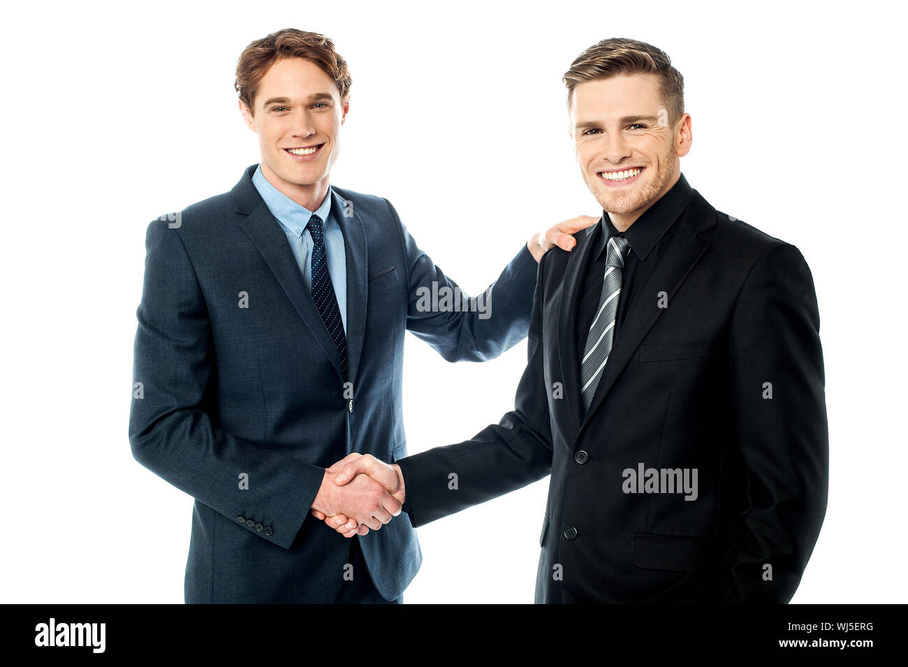 Handsome businessmen shaking hands Stock Photo - Alamy