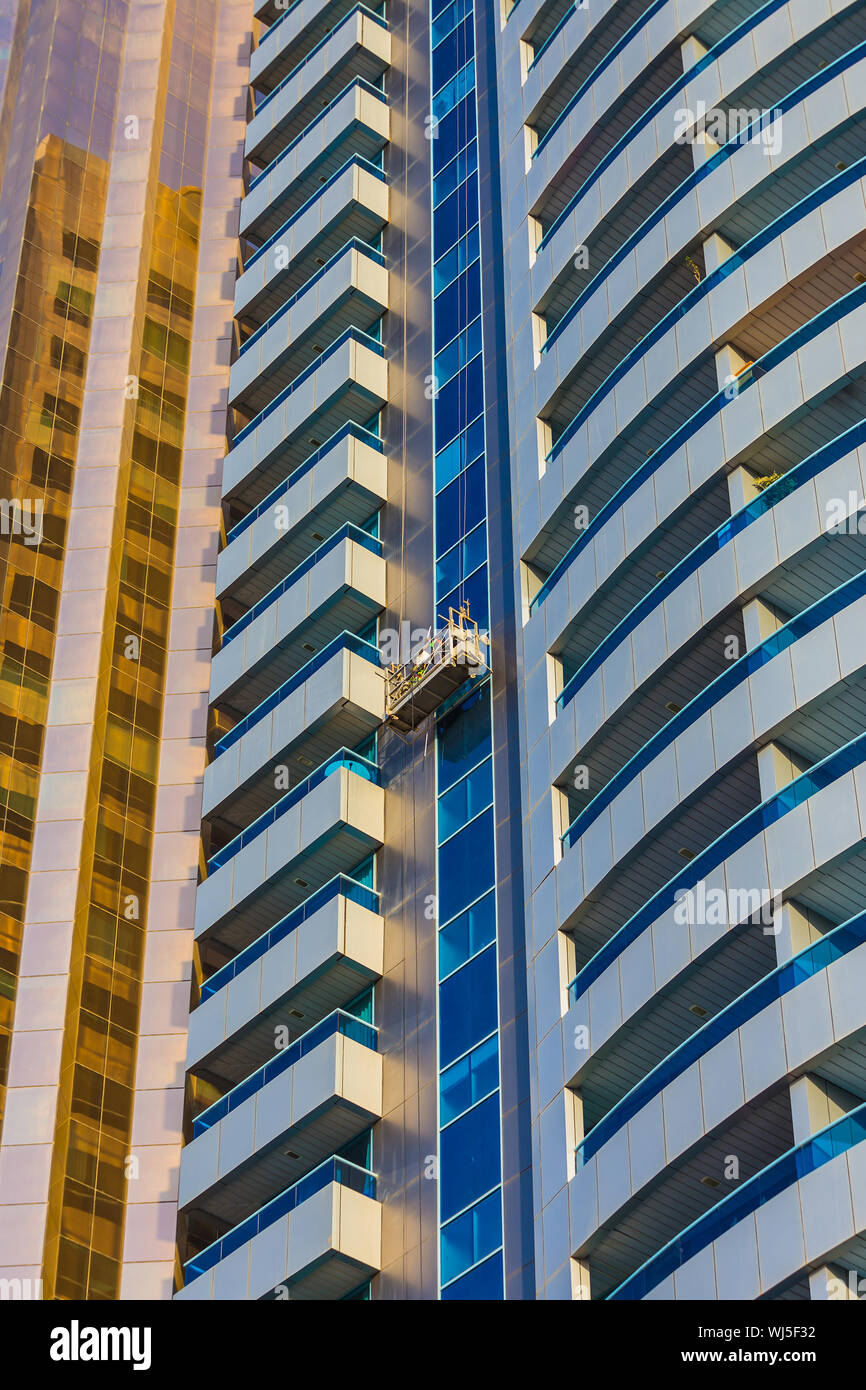 window cleaners in a gondola cleaning the windows of a corporate office ...
