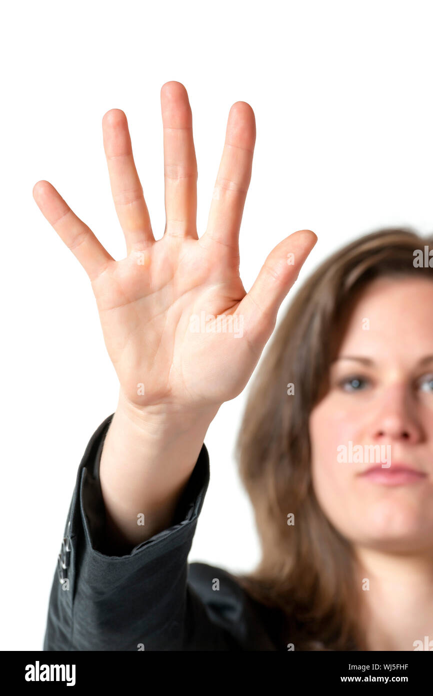 Business woman in black suit holds her hand up to stop someone or ...