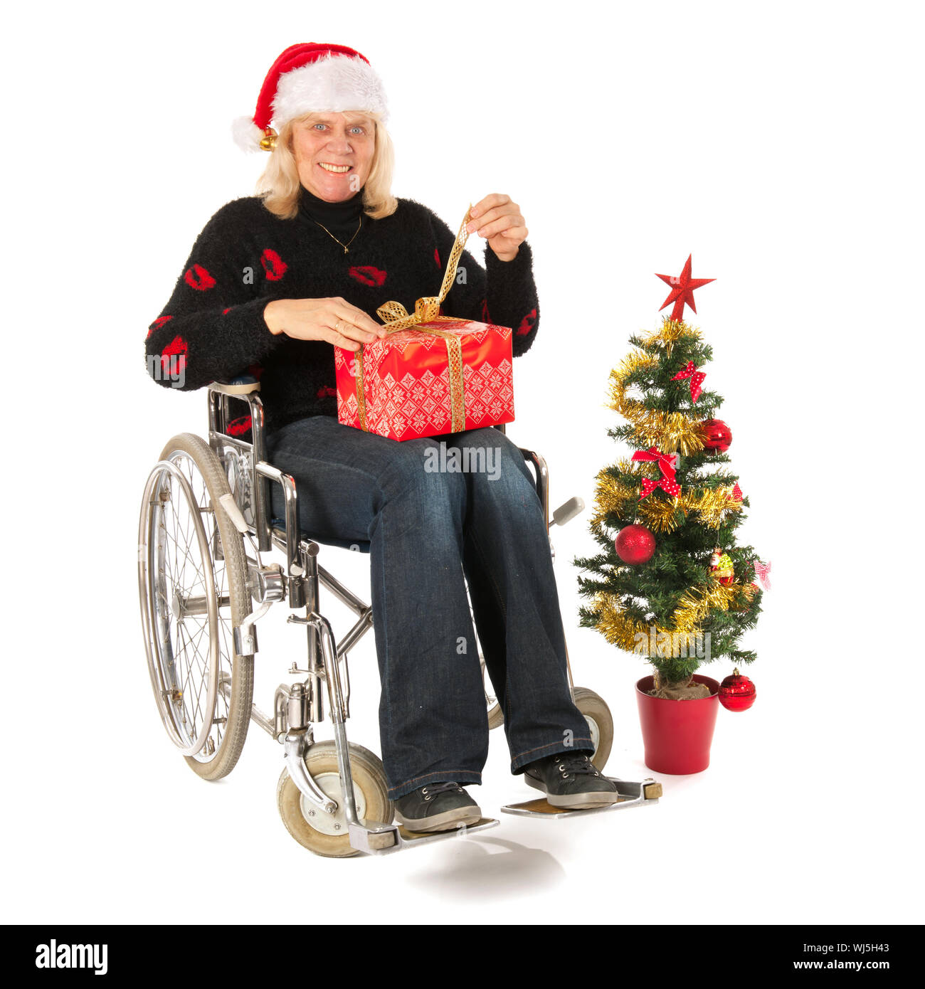Chirstmas time with gifts and tree in wheelchair isolated over white ...