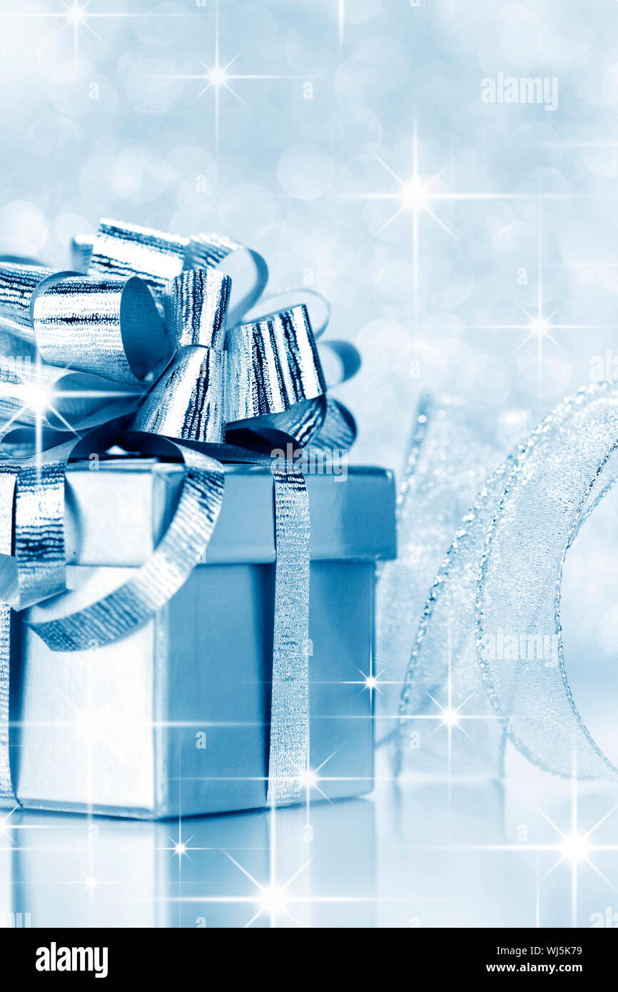 Christmas gift box with decoration on shiny stars background Stock ...