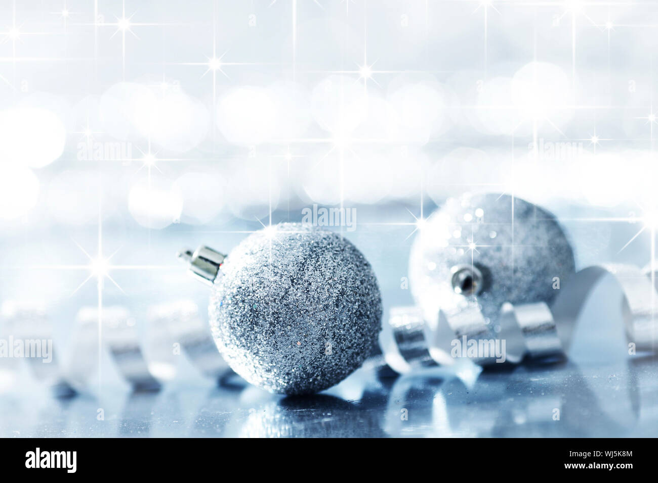 Silver christmas decorative balls on shiny stars background Stock Photo ...