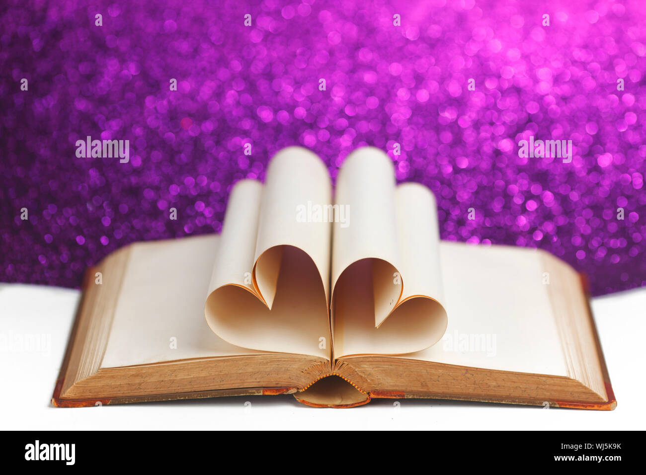 Heart made of blank pages inside a book on glitter background Stock ...