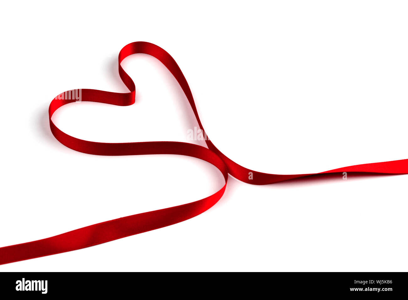 Red ribbon heart isolated on white background Stock Photo - Alamy