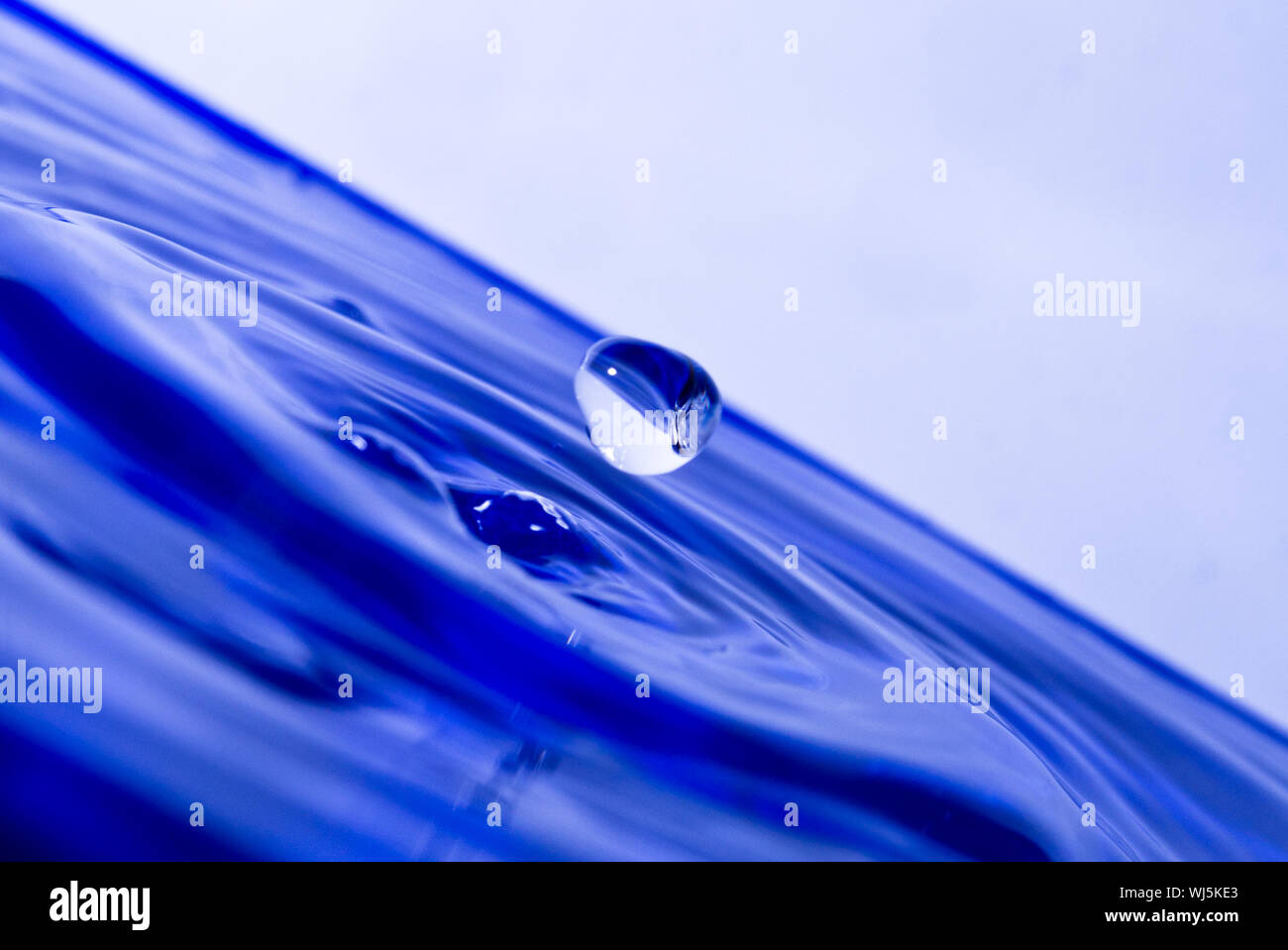 water dropping into surface Stock Photo - Alamy
