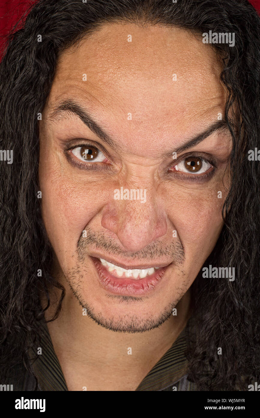 Close up of angry single man with long hair Stock Photo - Alamy