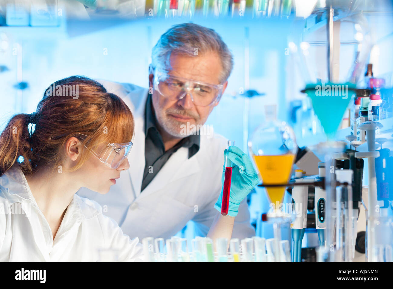 Attractive young female scientist and her senior male supervisor ...