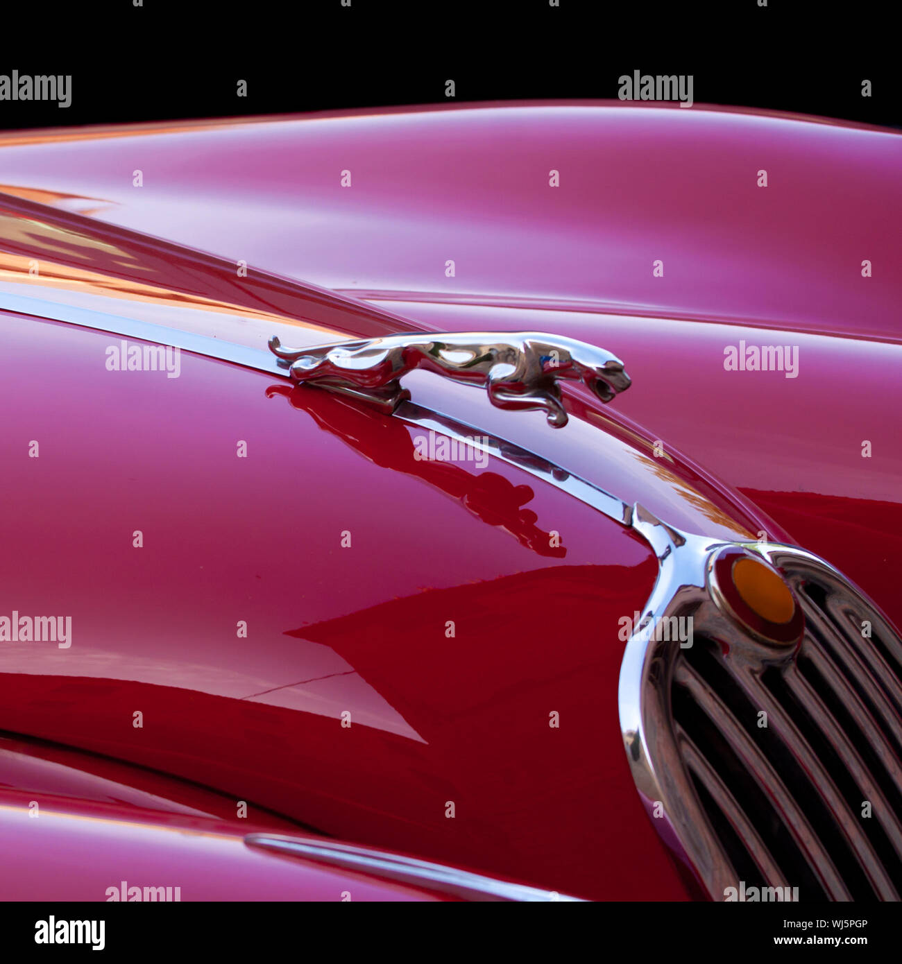 Detail of the metallic red luxury retro sports car Stock Photo - Alamy