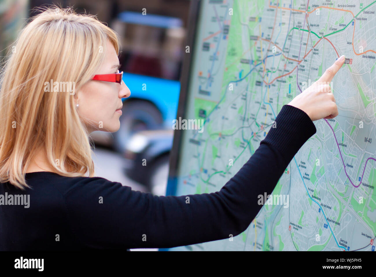 Woman orientating herself on the public transport map Stock Photo - Alamy
