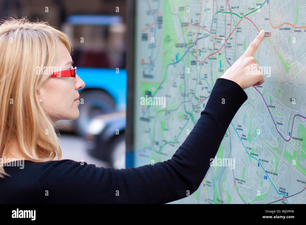 Woman orientating herself on the public transport map Stock Photo - Alamy