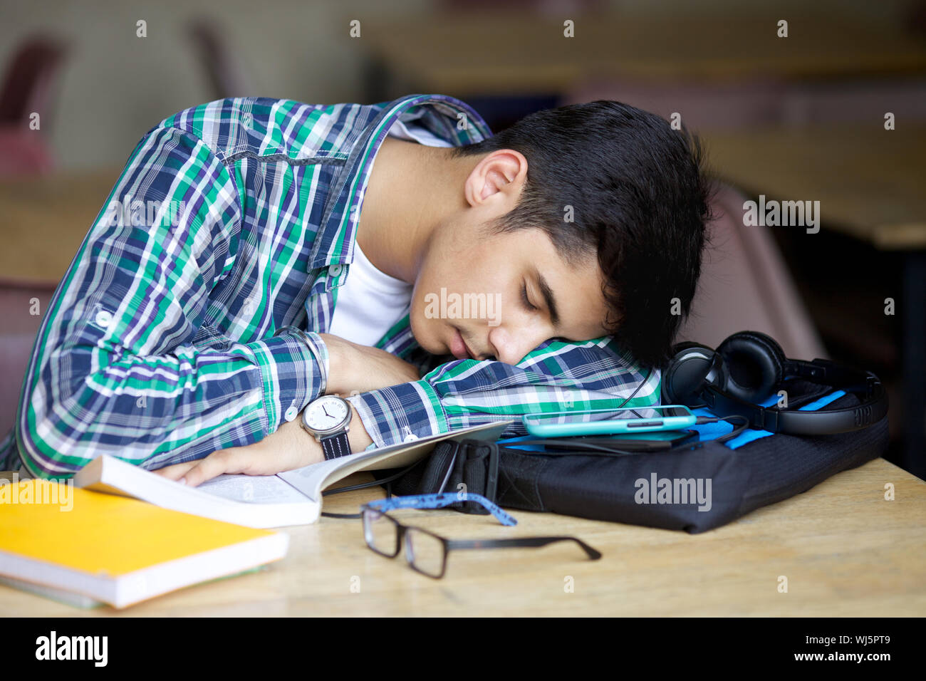 College student napping in a cafeteria Stock Photo - Alamy