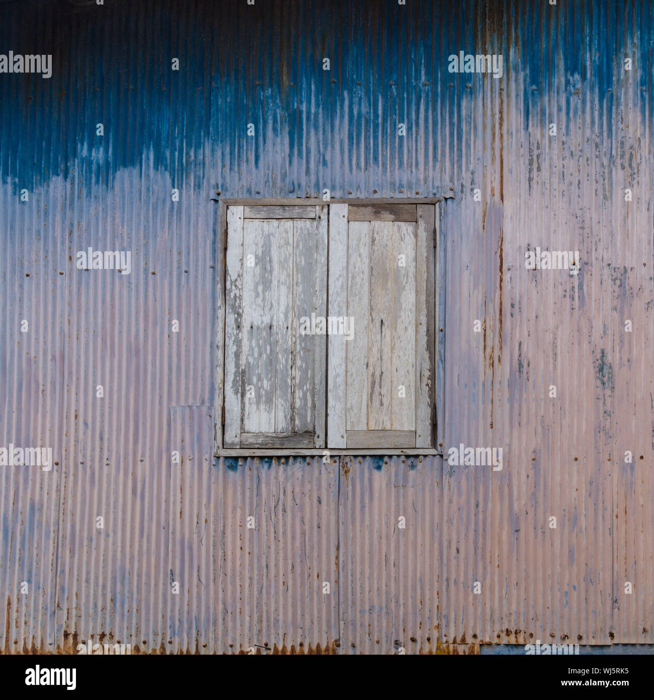 Old rusty house with closed wooden shutters; can be used as a graphical ...
