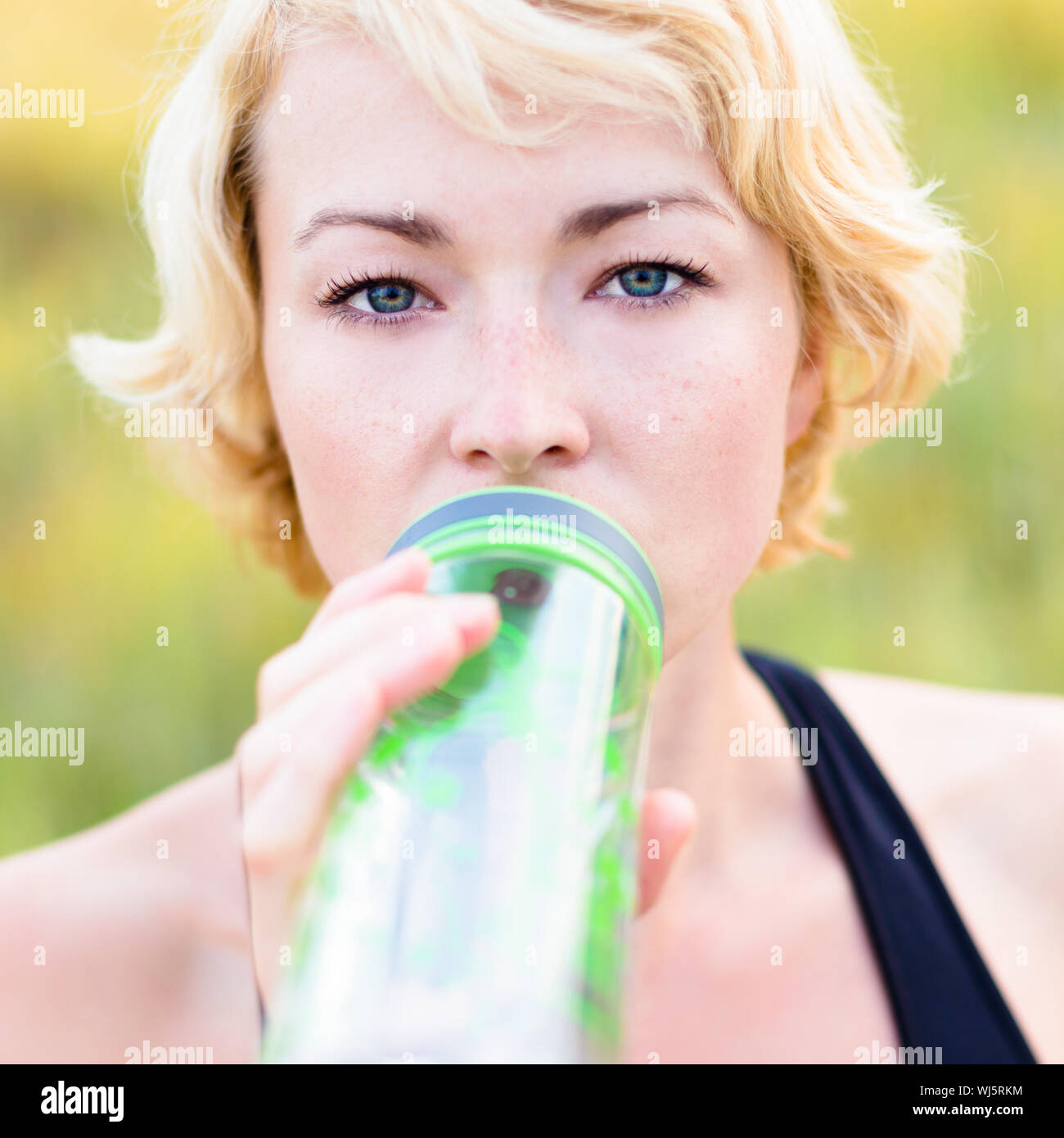 Lady drinking from the bottle during outdoor activities Stock Photo - Alamy