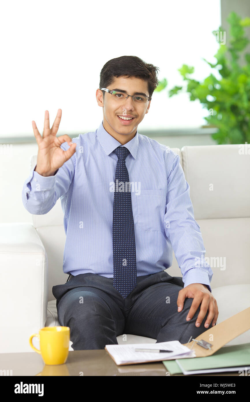 Smiling businessman showing ok sign hi-res stock photography and images ...