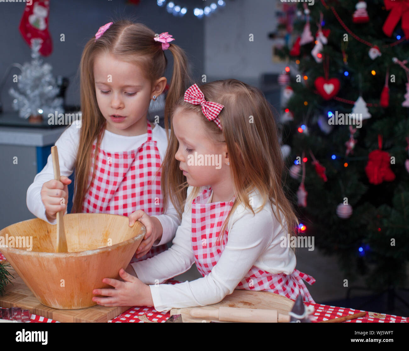 Little cute sisters bake gingerbread cookies for Christmas Stock Photo ...