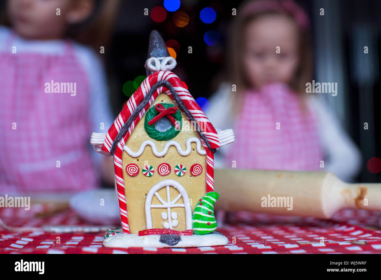 Gingerbread fairy house decorated by colorful candies on a background ...