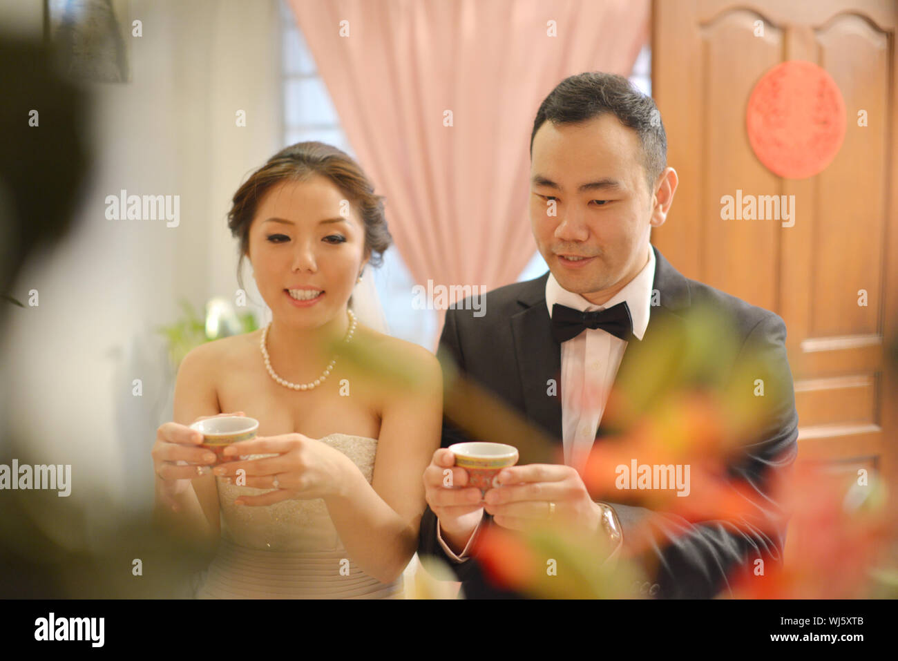 Traditional Chinese wedding, bride and groom serving tea in ceremony ...