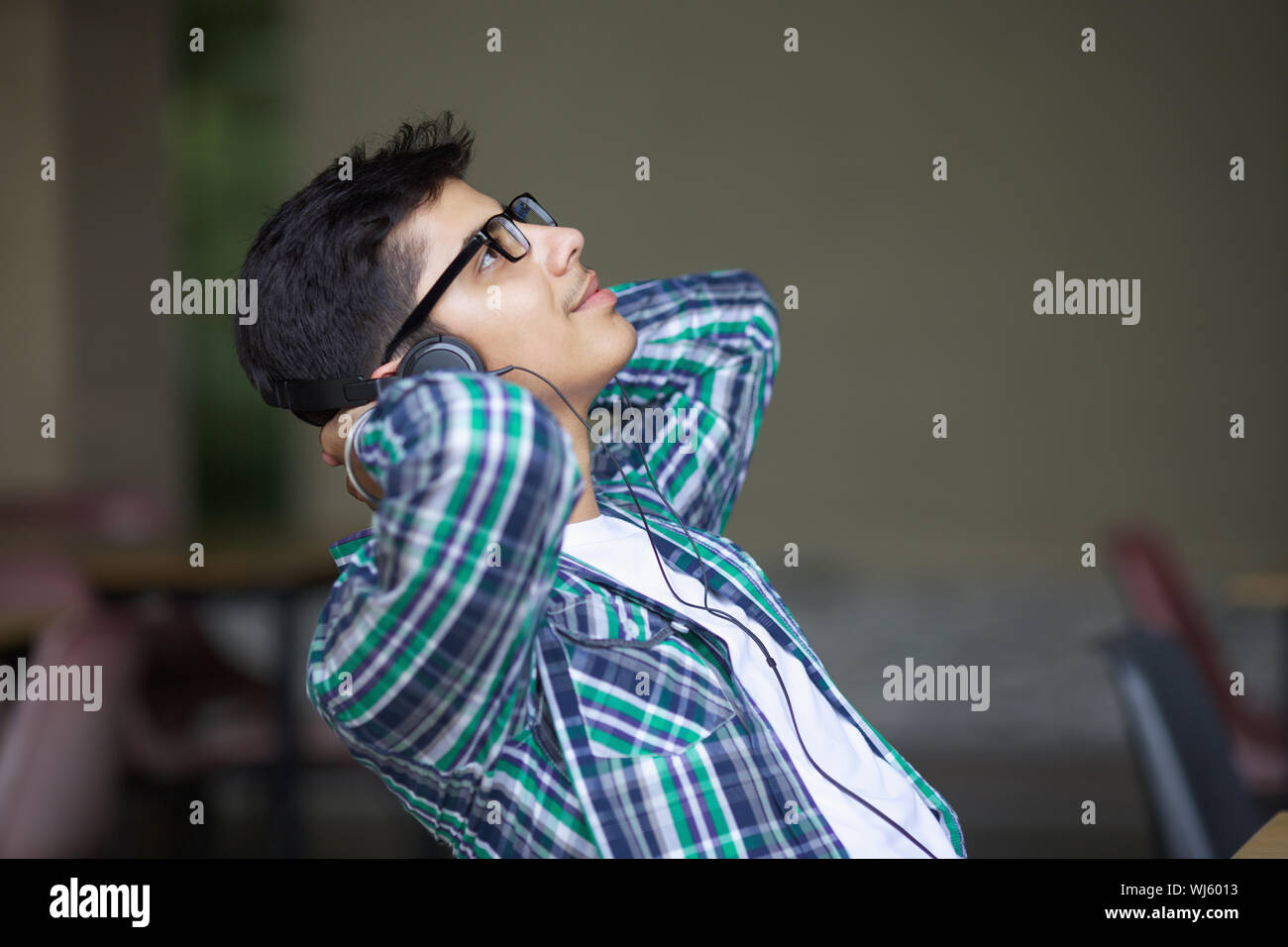 College student relaxing in a cafeteria Stock Photo - Alamy