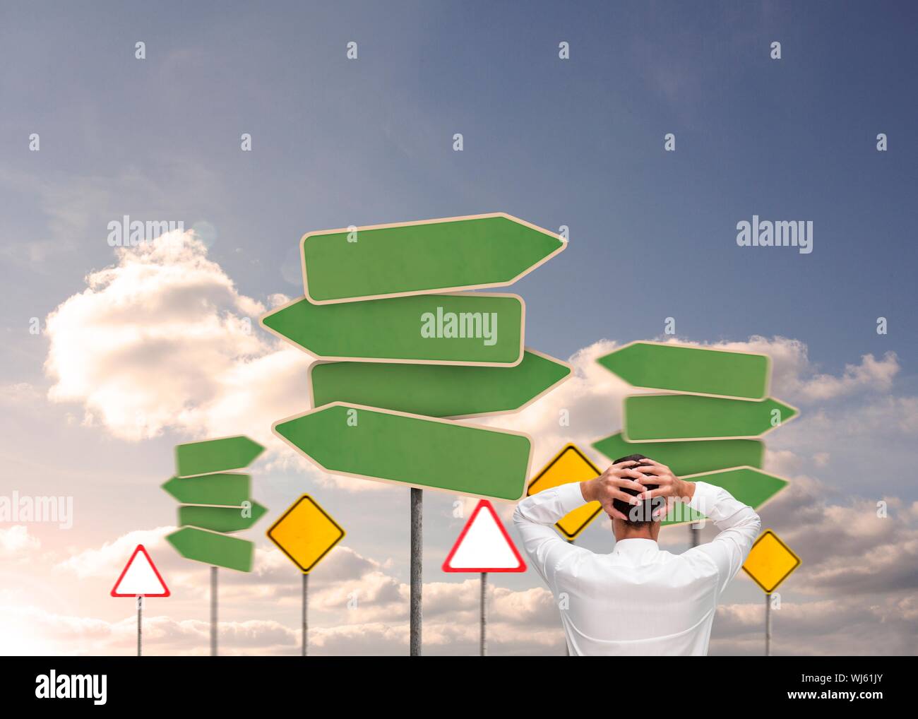 Composite image of businessman standing back to camera hands on head ...