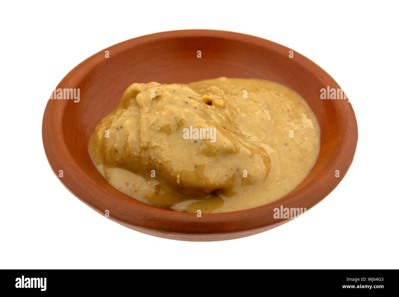 Side view of organic cashew nut butter in a small bowl isolated on a ...