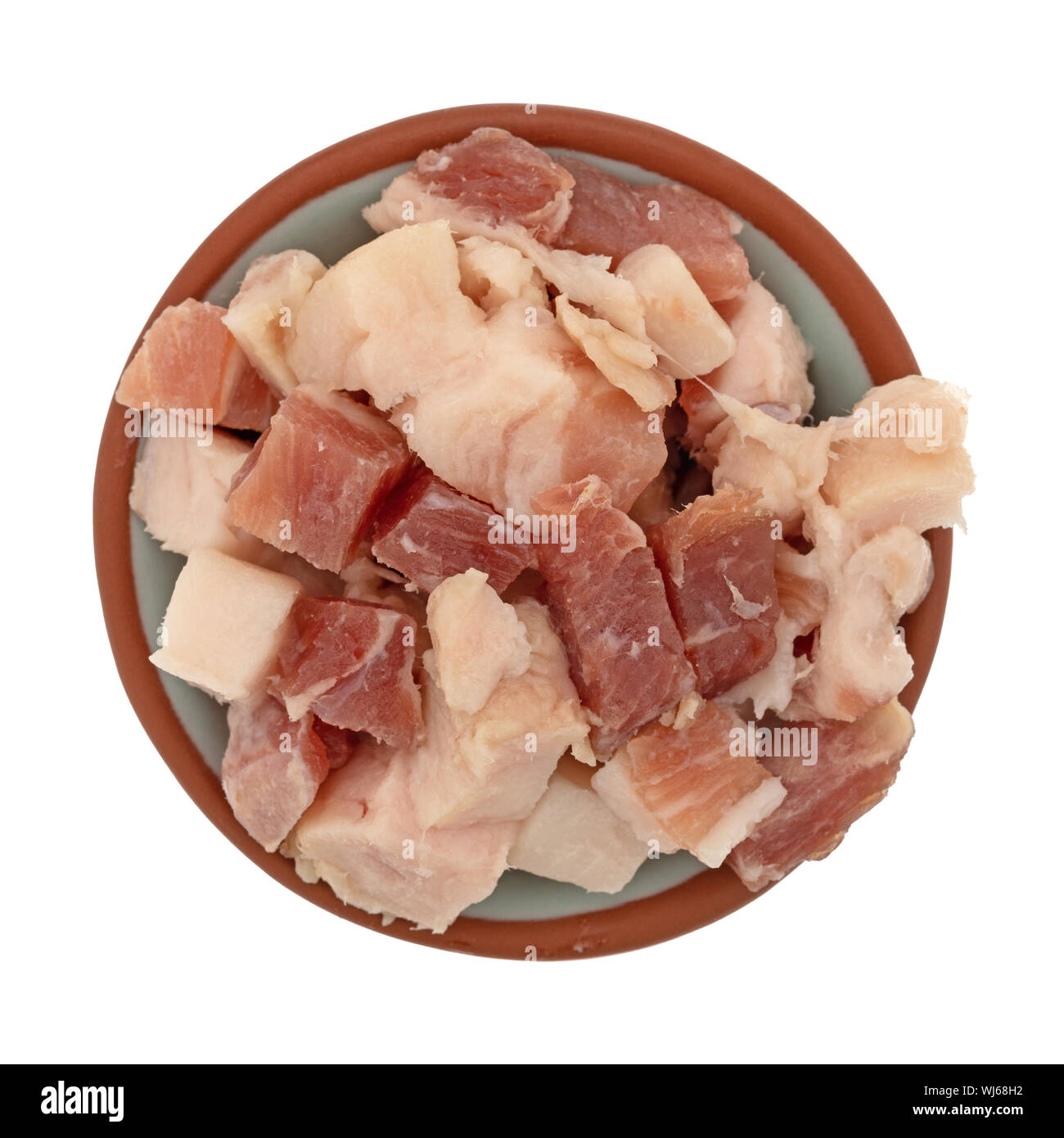 Top view of pancetta sliced into cubes in a small bowl isolated on a ...