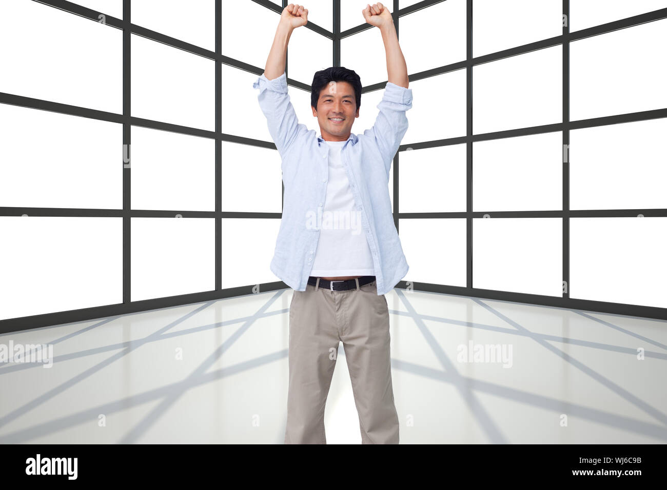 Composite image of cheering male with arms up Stock Photo - Alamy