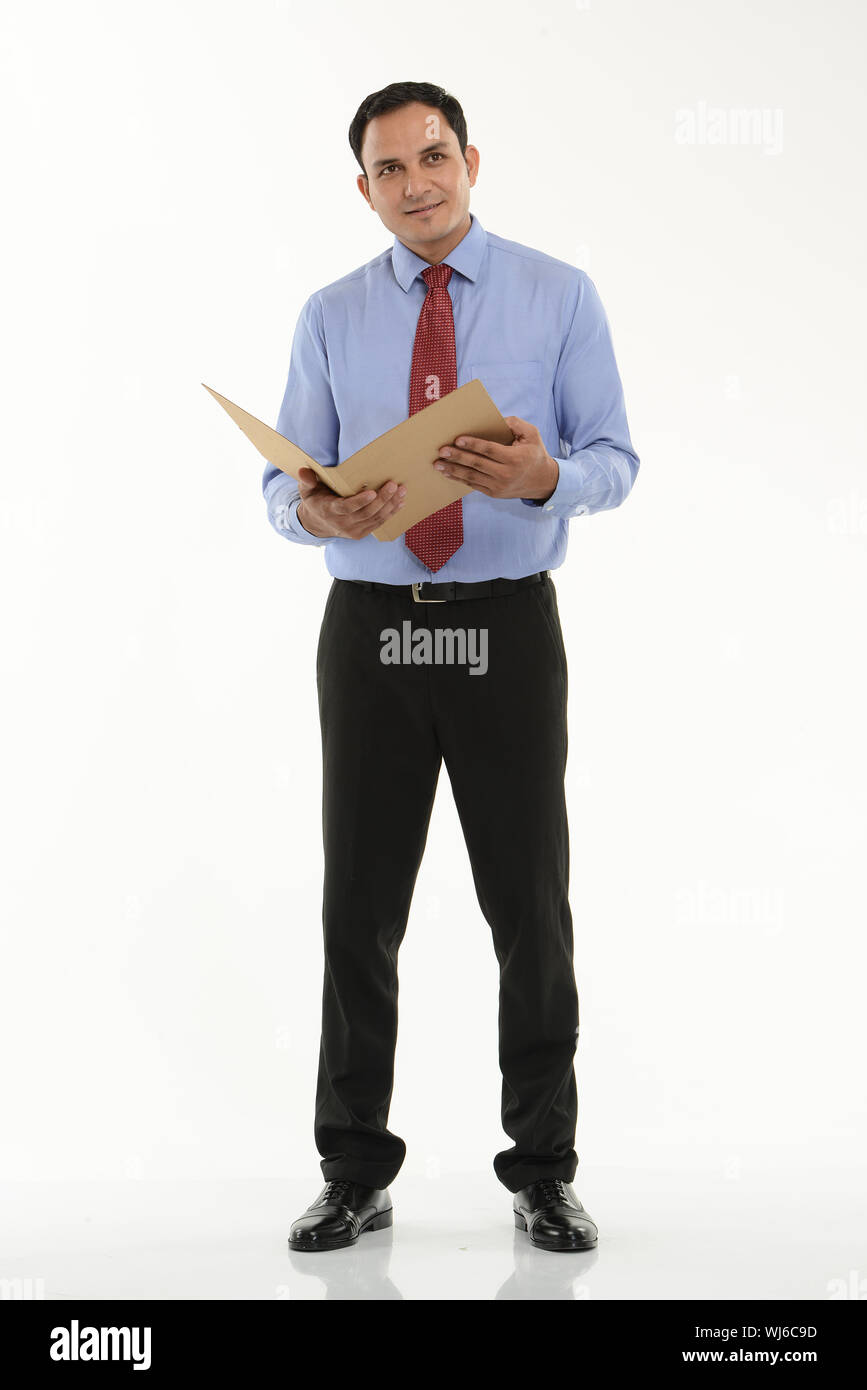 Businessman examining document Stock Photo - Alamy