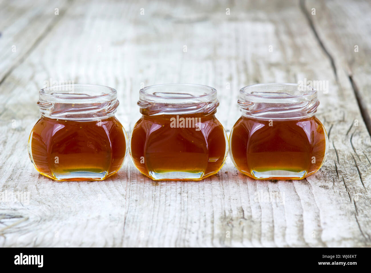 three jars of honey Stock Photo - Alamy