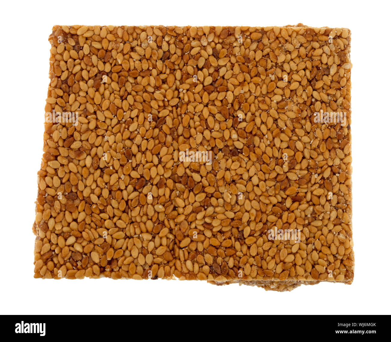 Single piece of sesame seed crunch candy isolated on a white background ...