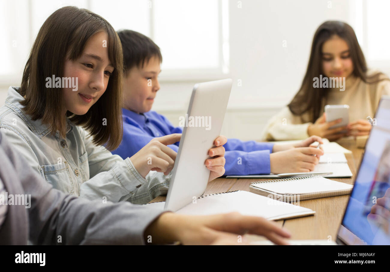 E-learning in school. Girl doing homework, using digital tablet Stock ...