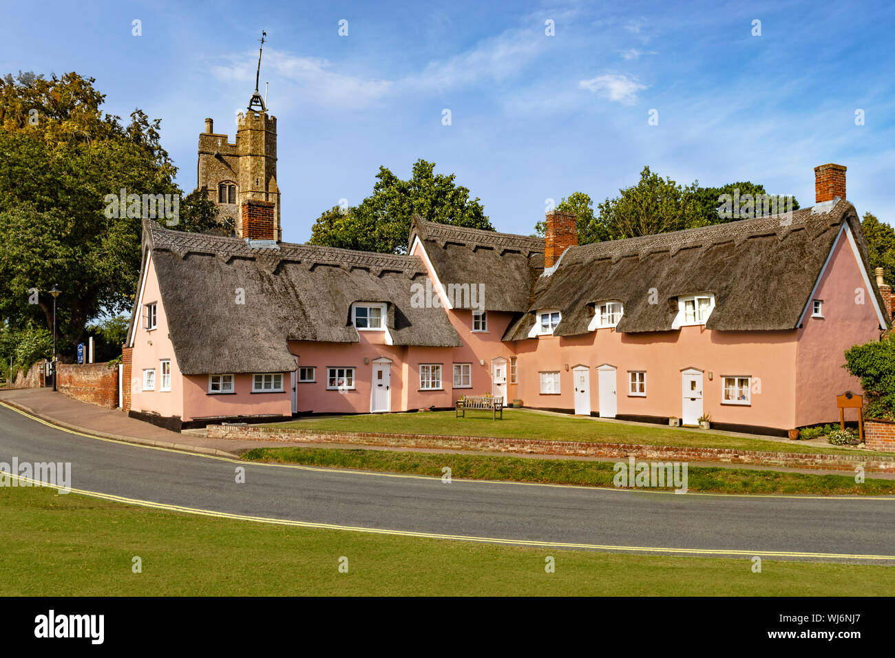 Pink Cottages with thatch rooftops and view of St Mary's Church, from ...